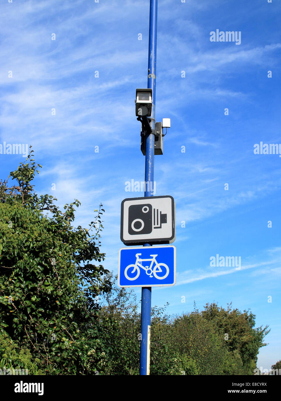 A traffic monitoring camera mounted on a post above the road together ...