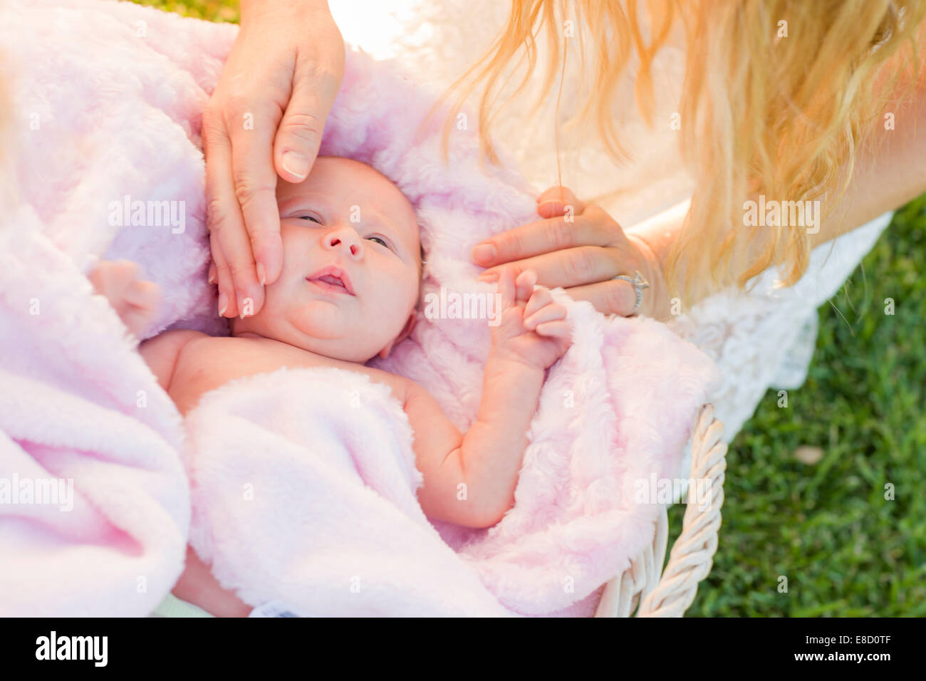 Gentle Hands of Mother Caressing Her Newborn Baby Girl in Pink Blanket ...