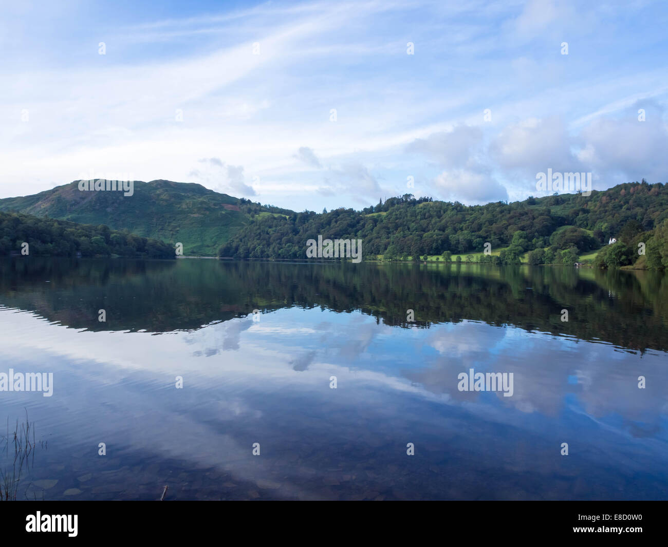 clouds and scenery reflecting in Grasmere water, The lake district ...
