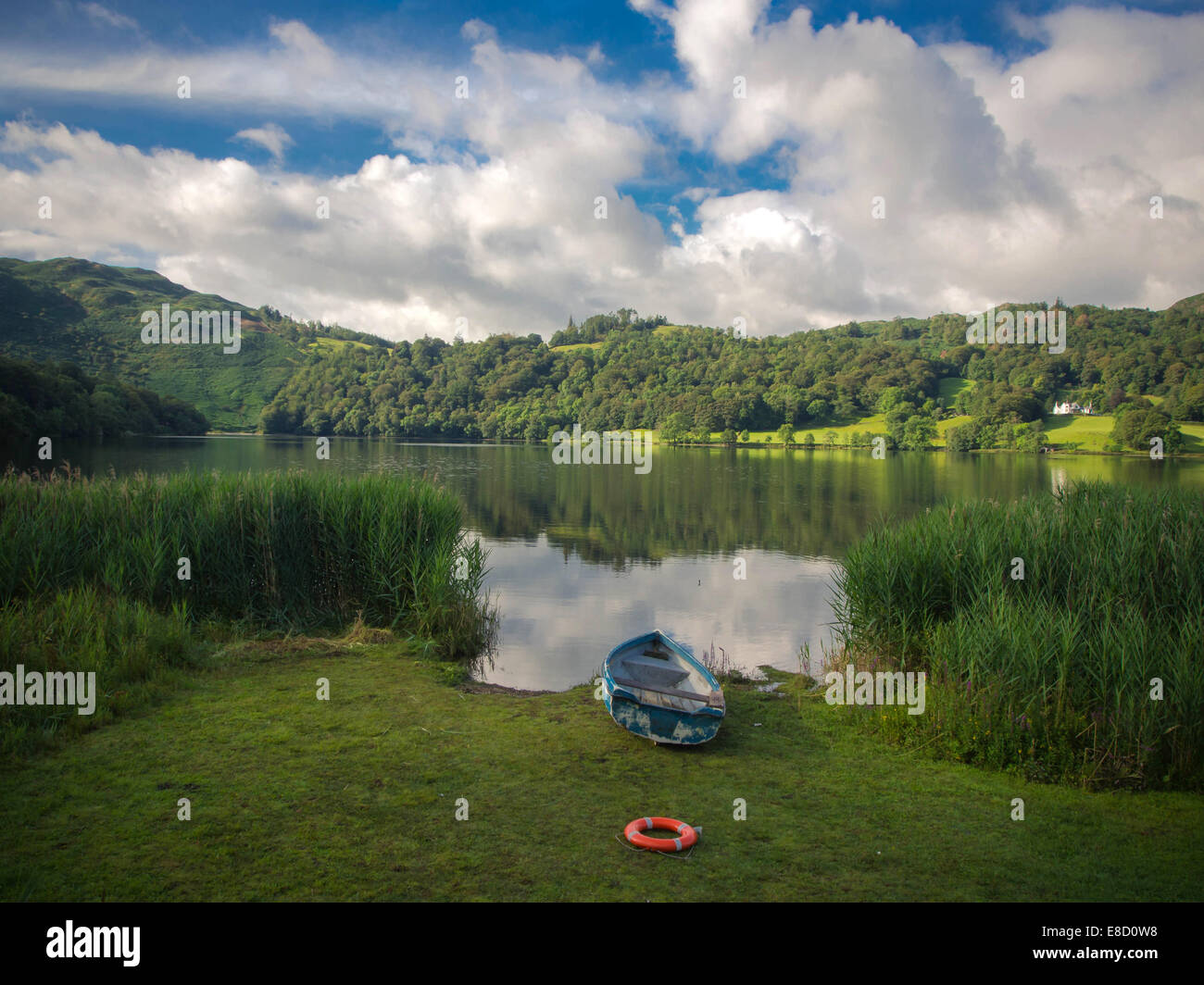A boat and life buoy on the shores of Grasmere Water in the Lake ...