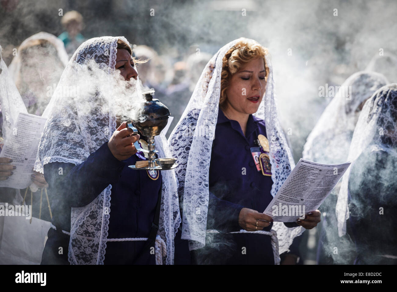 Peruvian women, known as "Sahumadoras", burn incense while ...
