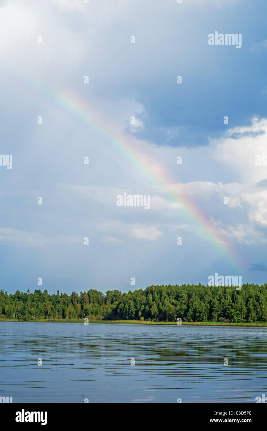 Rainbow over lake Stock Photo - Alamy
