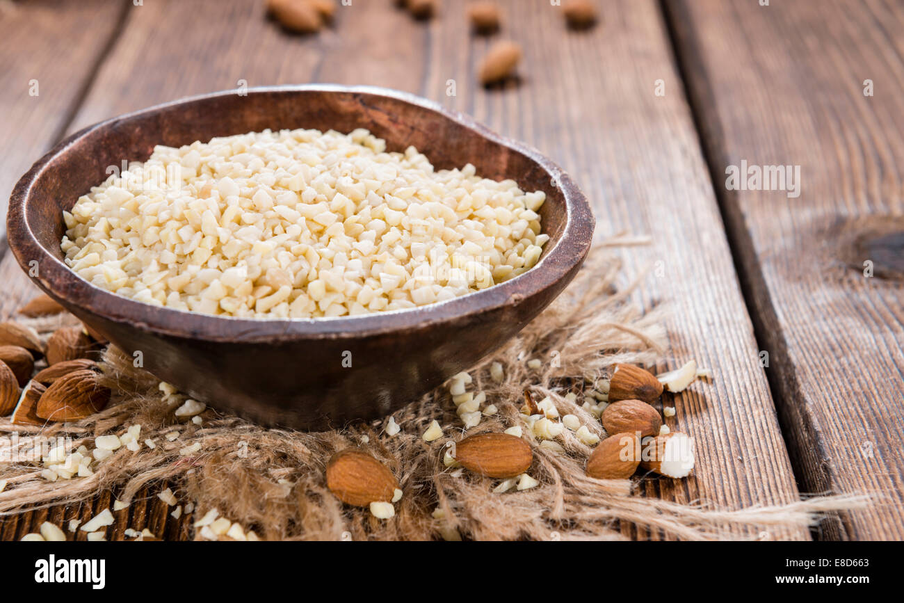 Minced Almonds (detailed close-up shot) on dark wooden background Stock ...