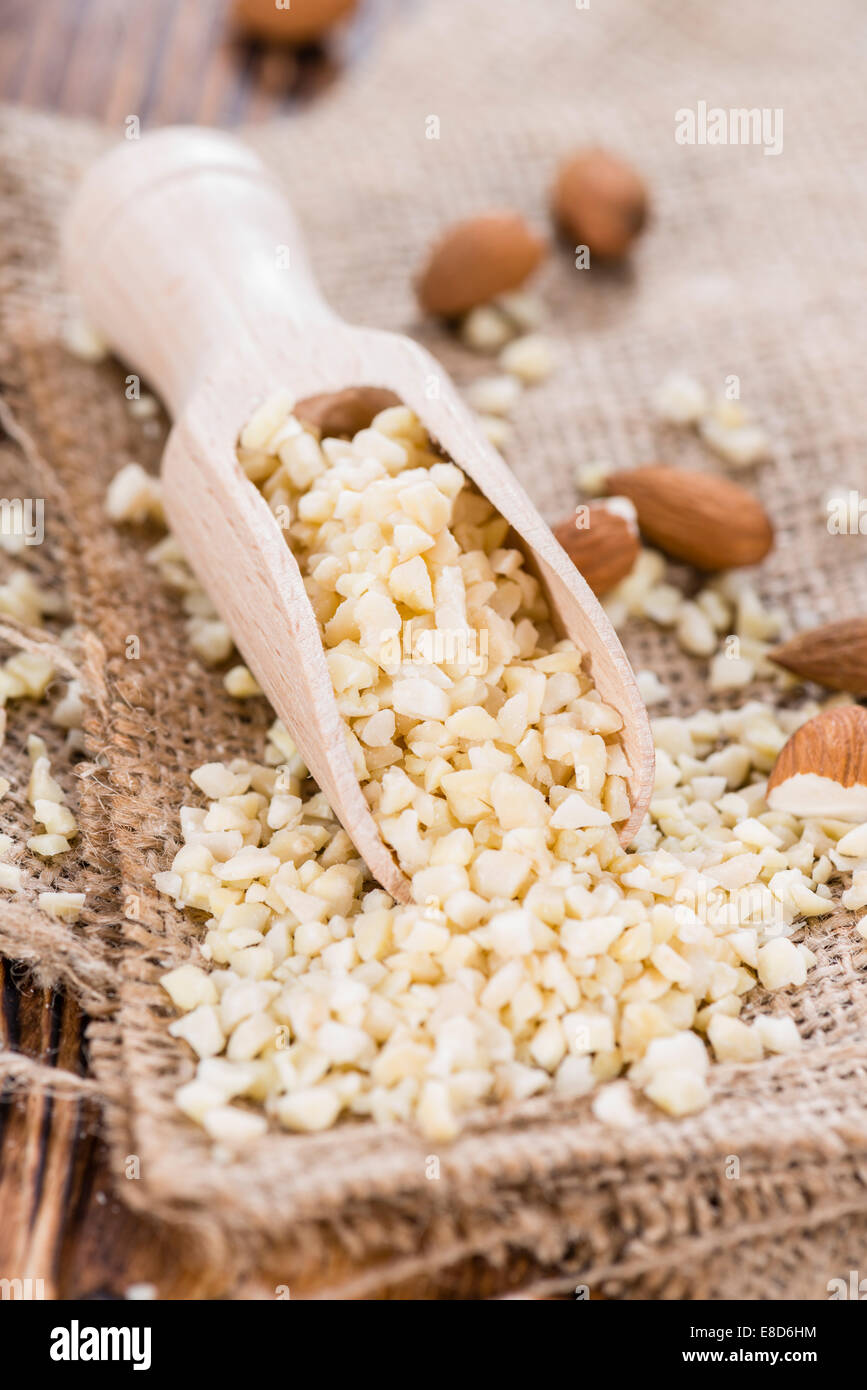 Minced Almonds (detailed close-up shot) on dark wooden background Stock ...