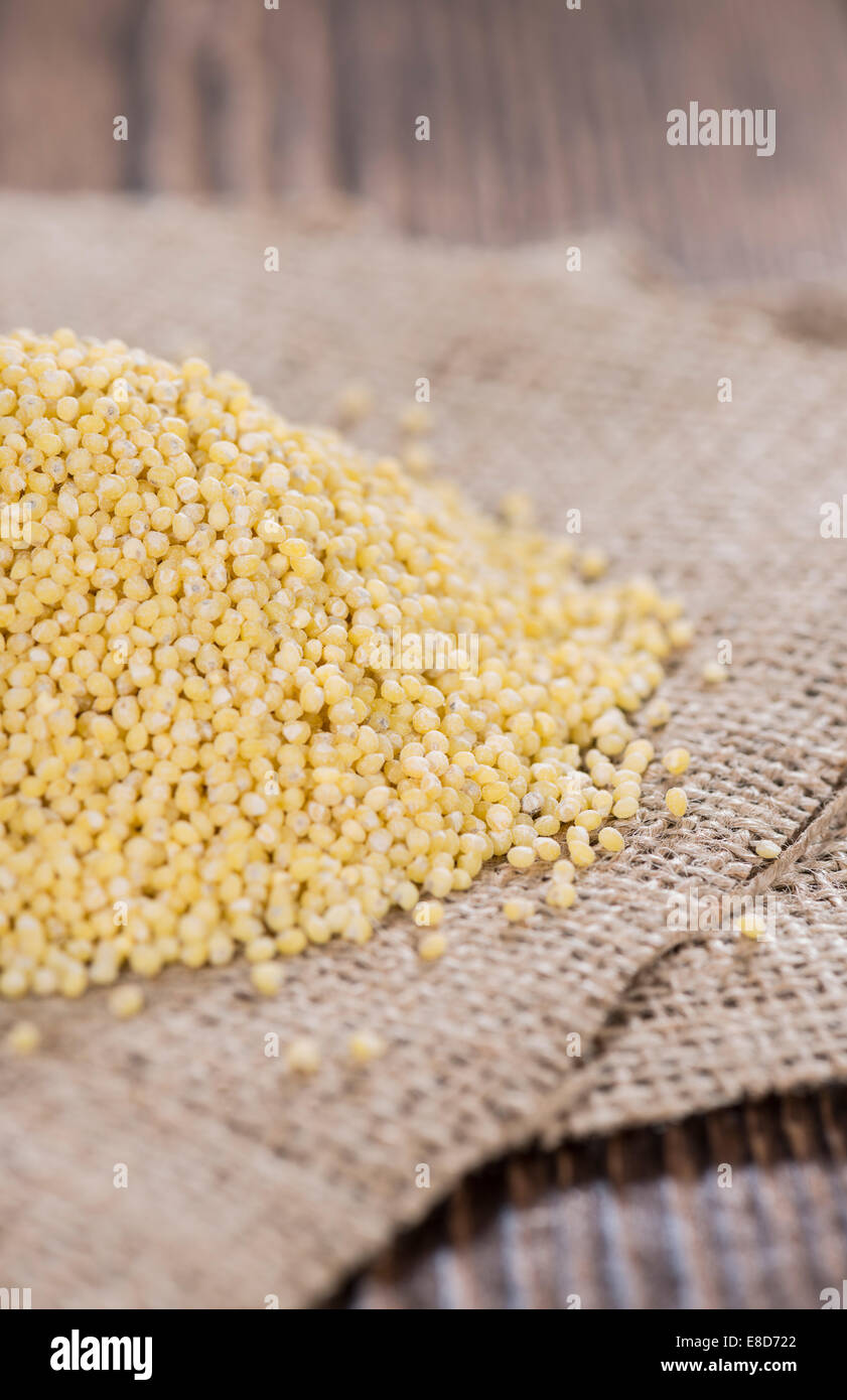 Heap of Millet on a dark vintage wooden table Stock Photo - Alamy