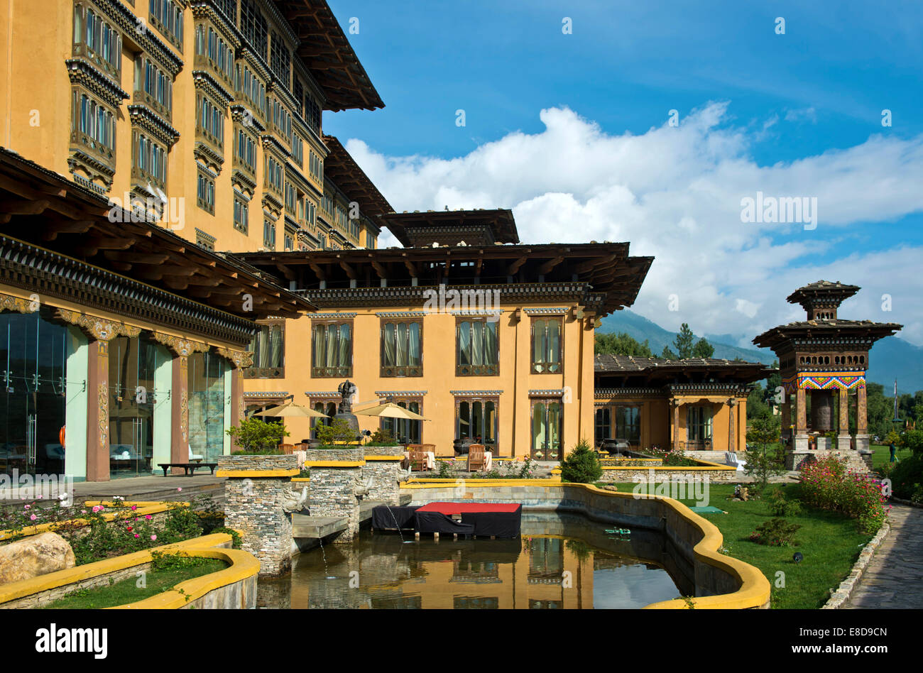 Gardens with a prayer wheel at the Taj Tashi Hotel, Thimphu, Bhutan ...