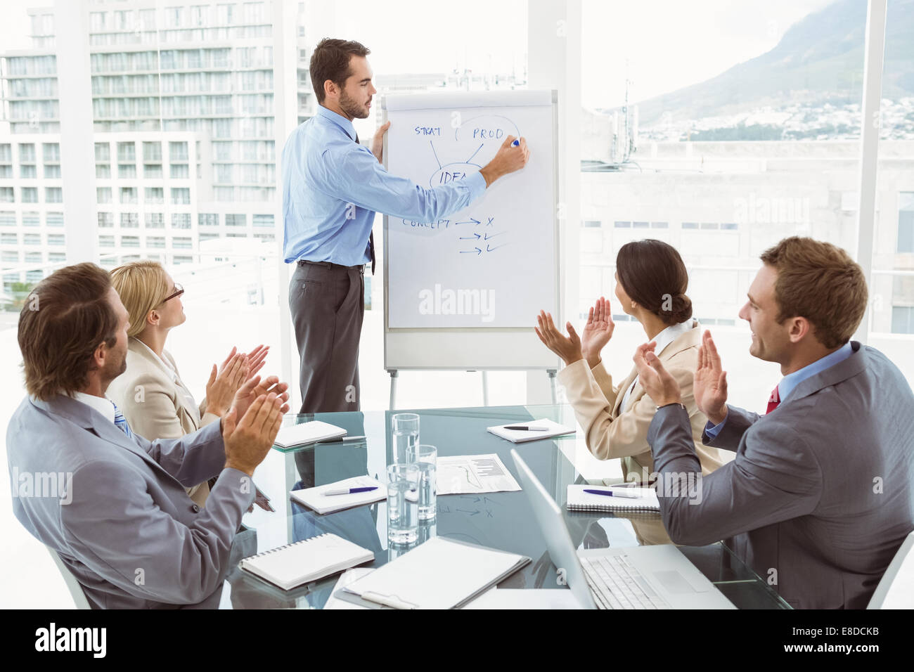 Business people clapping hands in board room meeting Stock Photo - Alamy