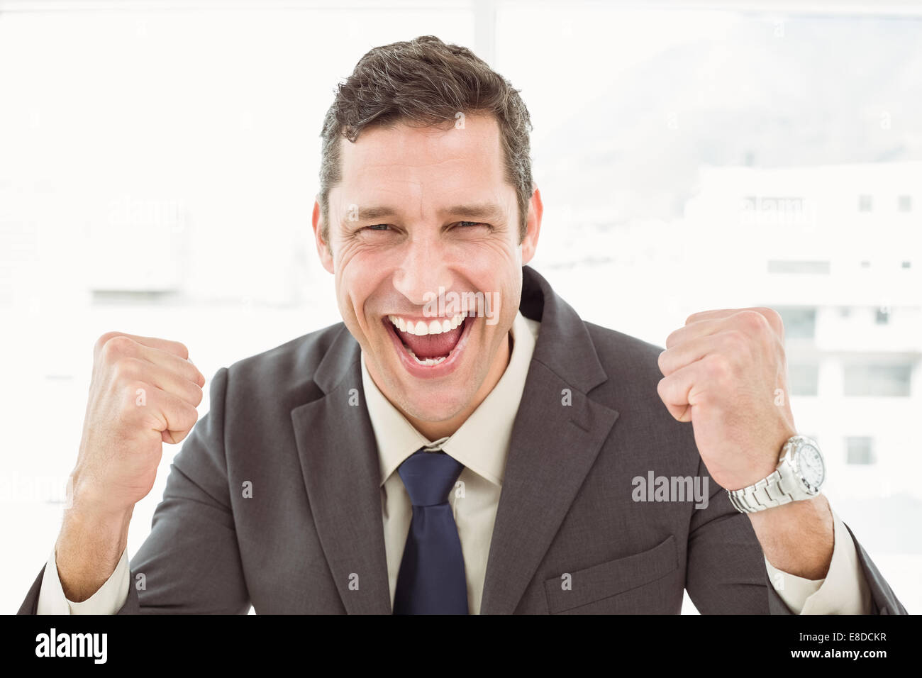 Cheerful businessman cheering in office Stock Photo - Alamy