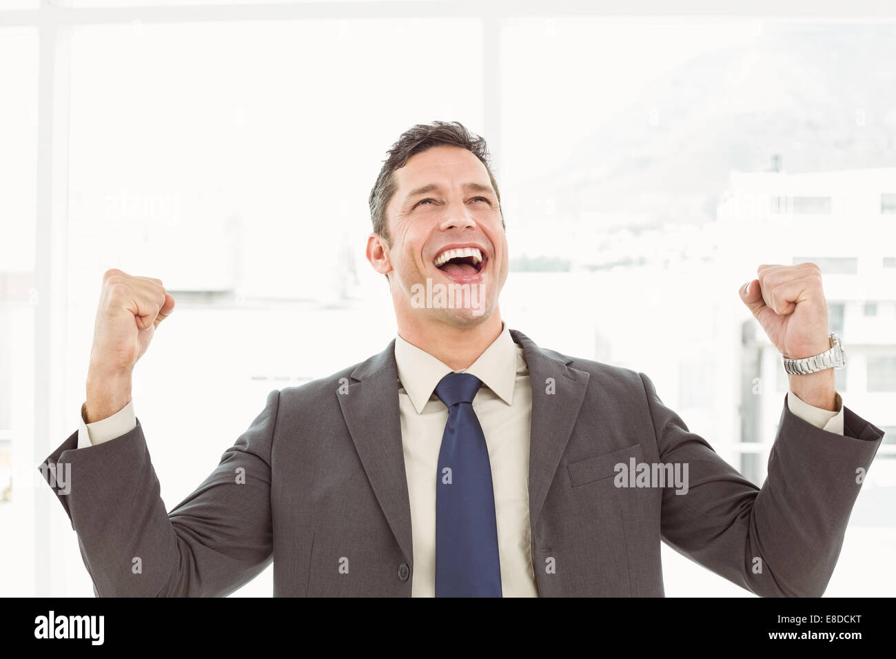 Cheerful businessman cheering in office Stock Photo - Alamy