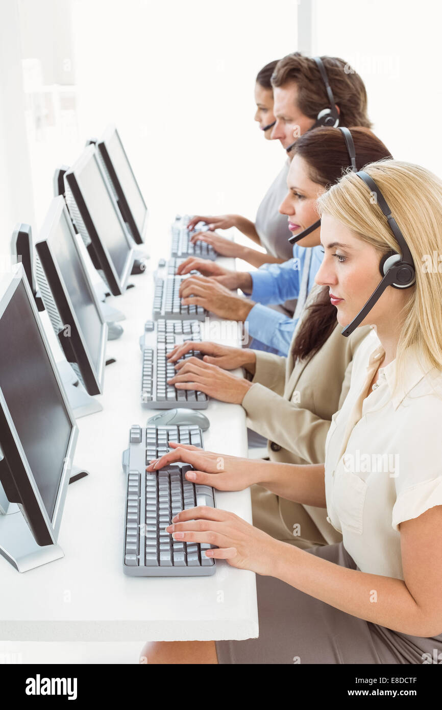 Business people with headsets using computers in office Stock Photo - Alamy