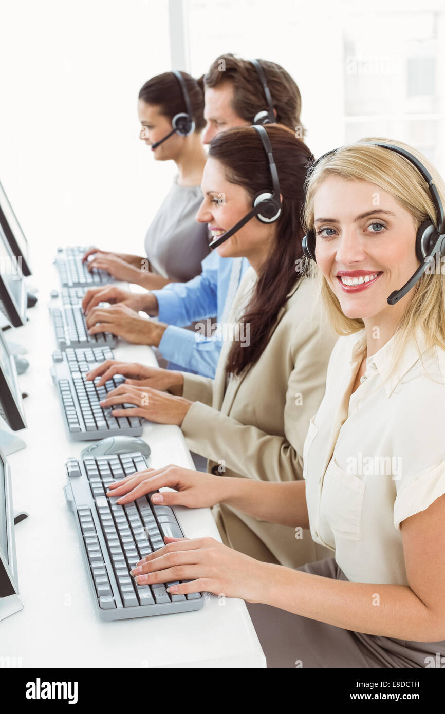 Business people with headsets using computers in office Stock Photo - Alamy