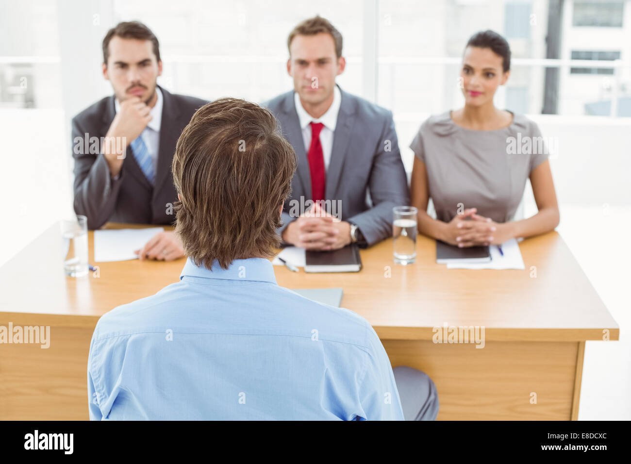 Business people interviewing man in office Stock Photo - Alamy