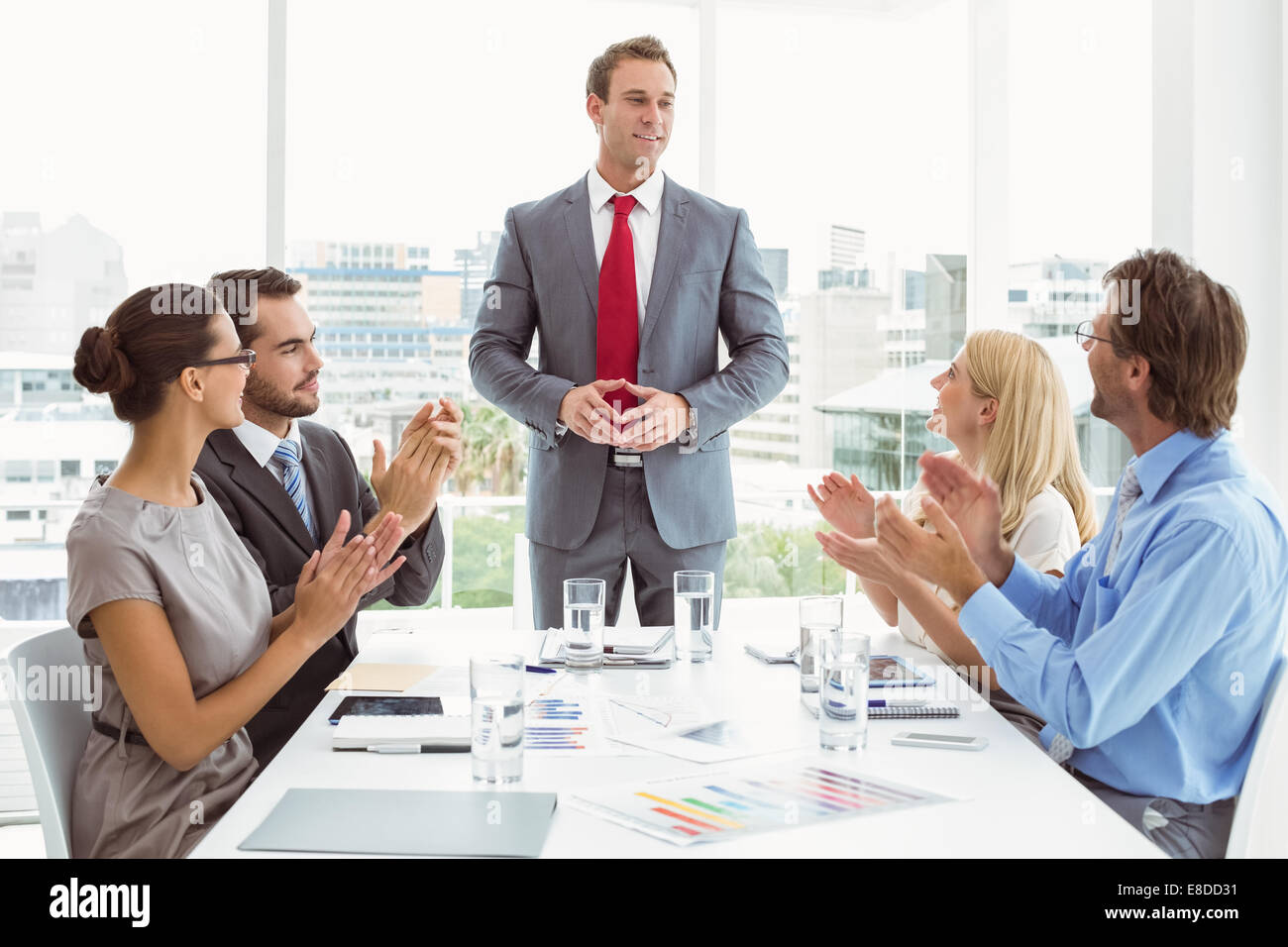 Business people clapping hands in board room meeting Stock Photo - Alamy