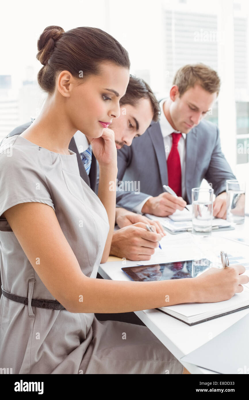 Business people writing notes in board room meeting Stock Photo - Alamy