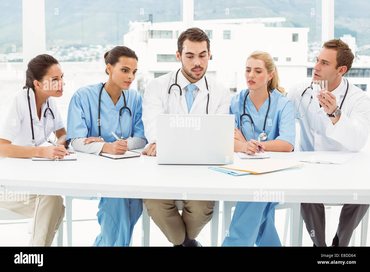 Male and female doctors using laptop Stock Photo - Alamy