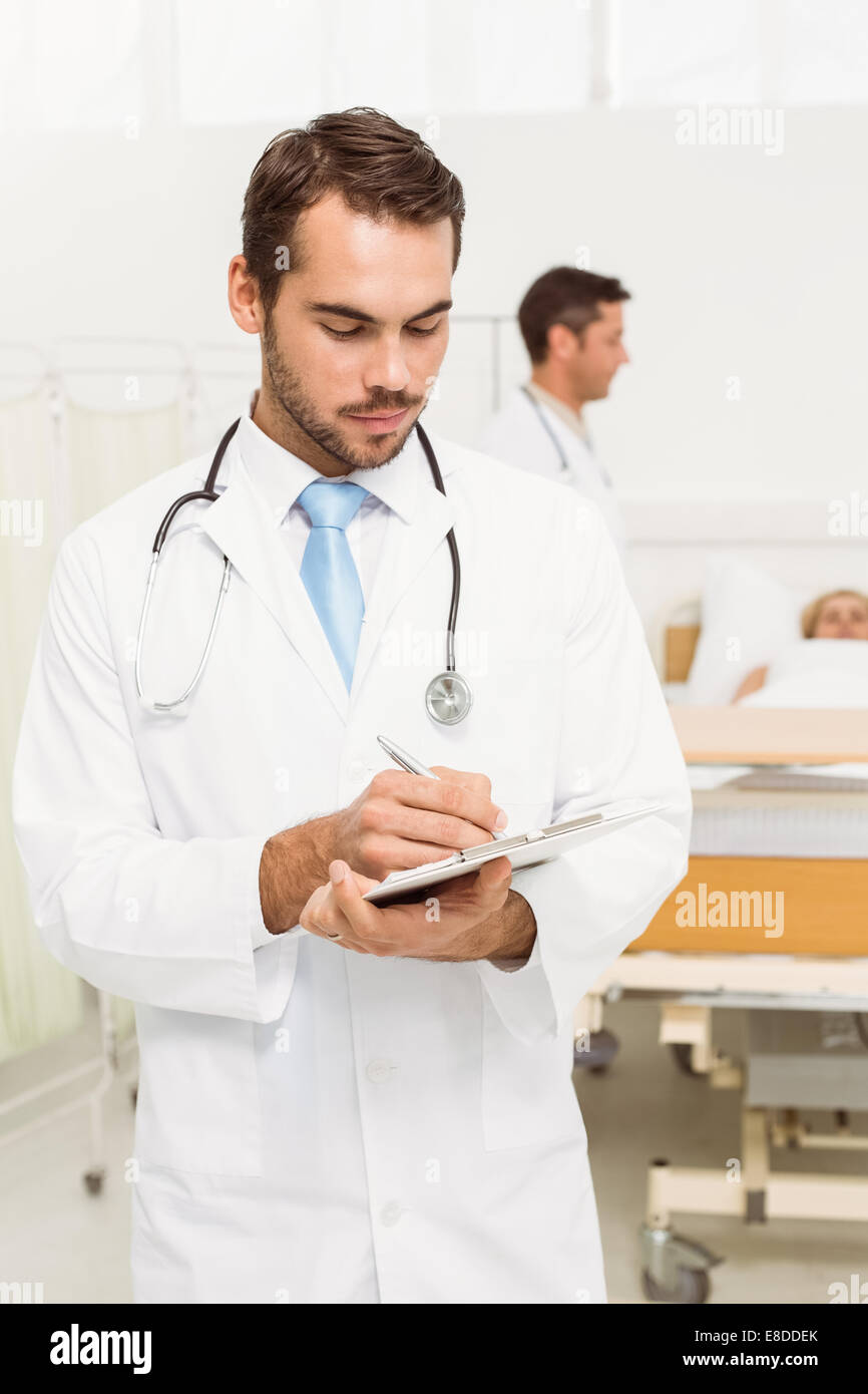Doctor with colleague and patient behind Stock Photo - Alamy