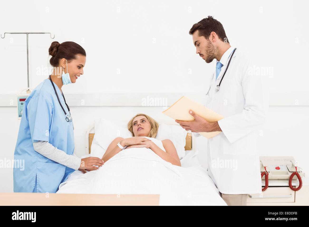 Doctors visiting patient in hospital Stock Photo - Alamy