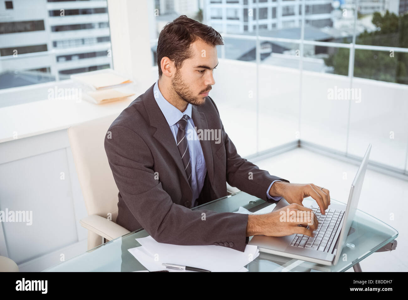 Businessman using laptop in office Stock Photo - Alamy