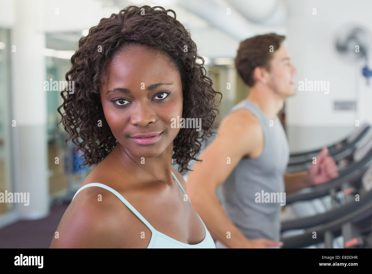 Fit woman smiling at camera on treadmill Stock Photo - Alamy