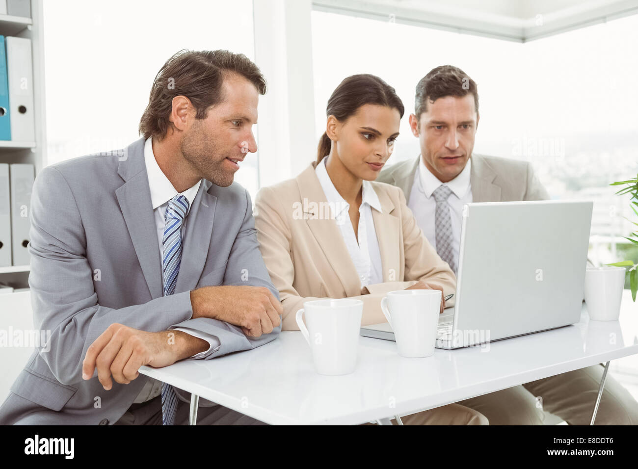 Business people using laptop in office Stock Photo - Alamy