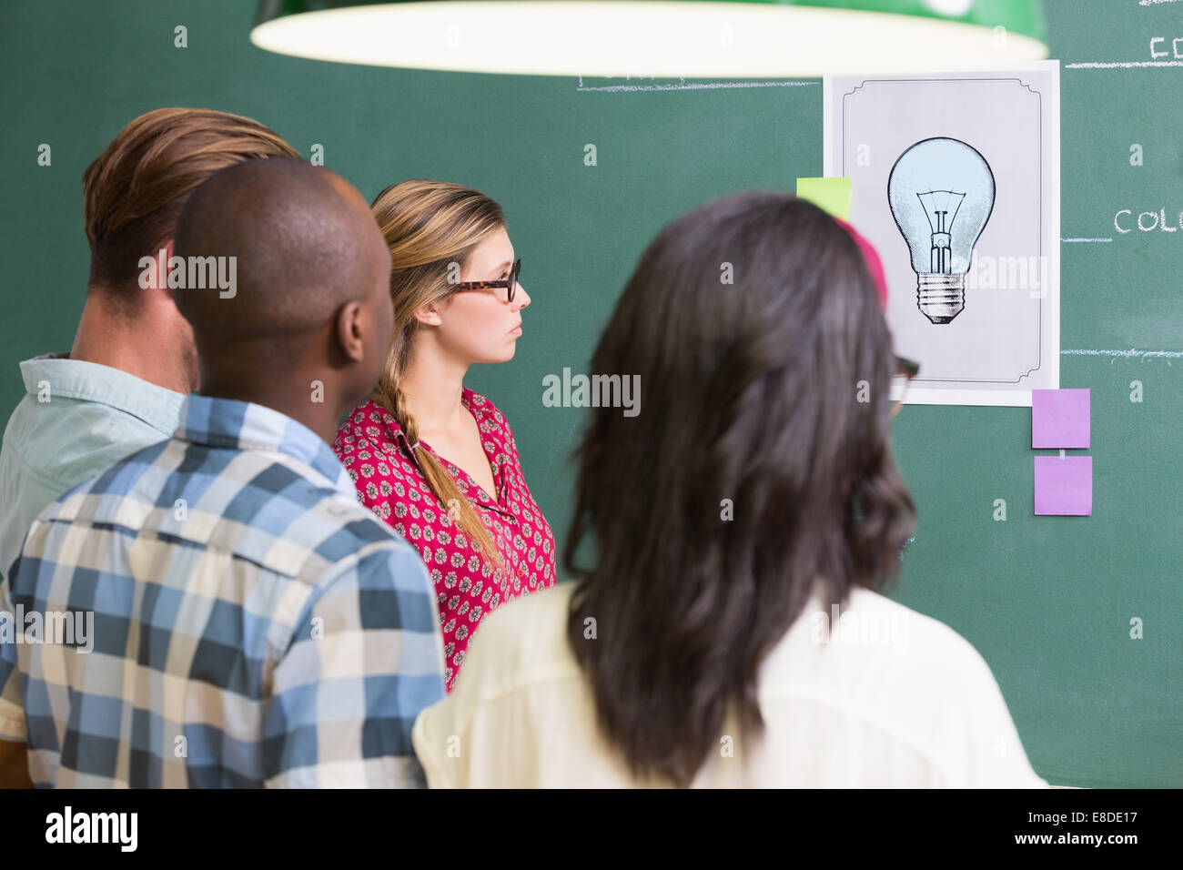 Creative business people at work by blackboard Stock Photo - Alamy