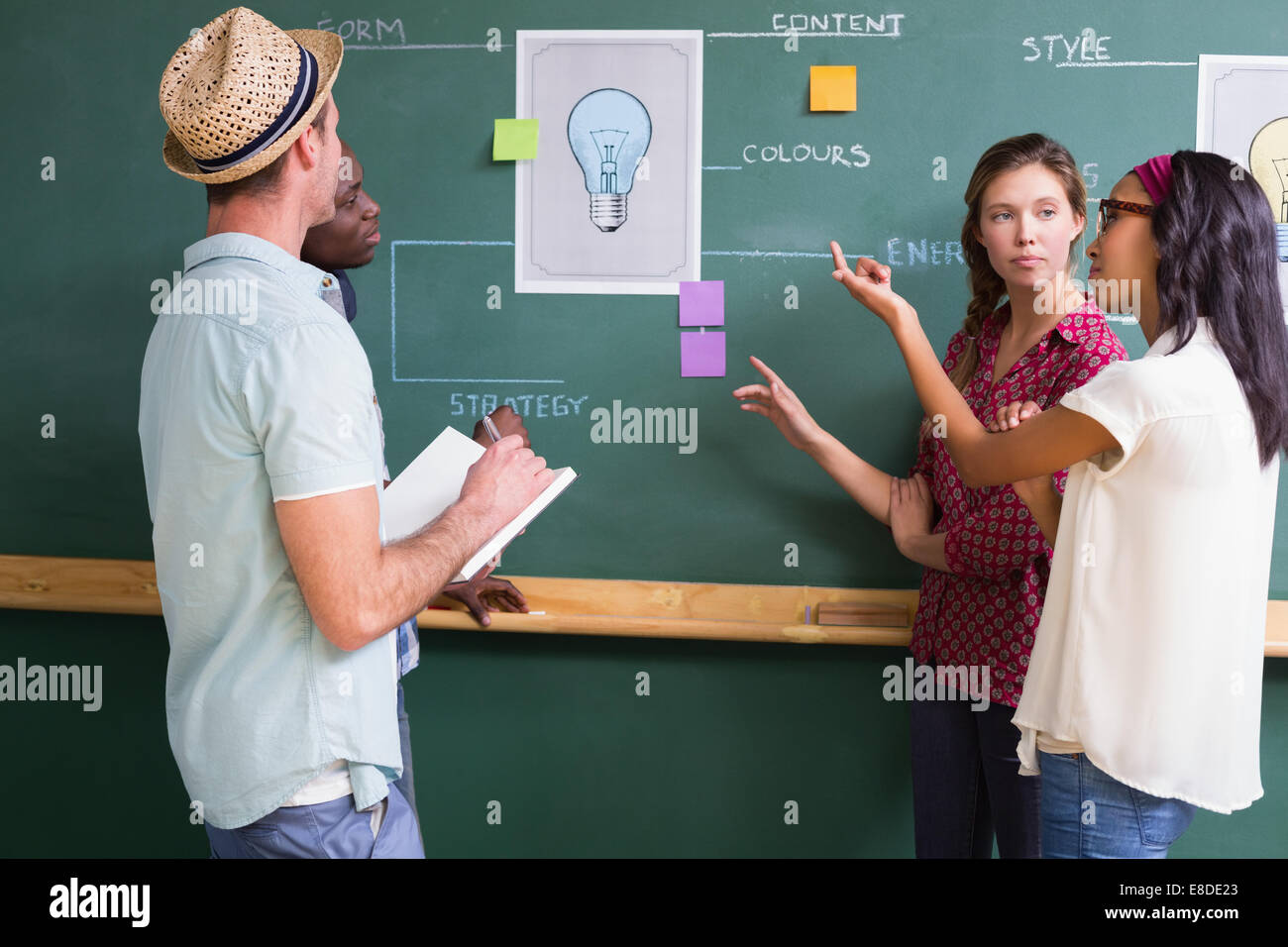 Creative business people at work by blackboard Stock Photo - Alamy