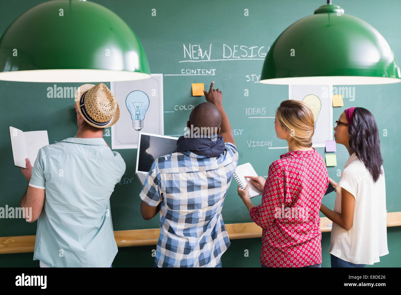 Creative business people at work by blackboard Stock Photo - Alamy