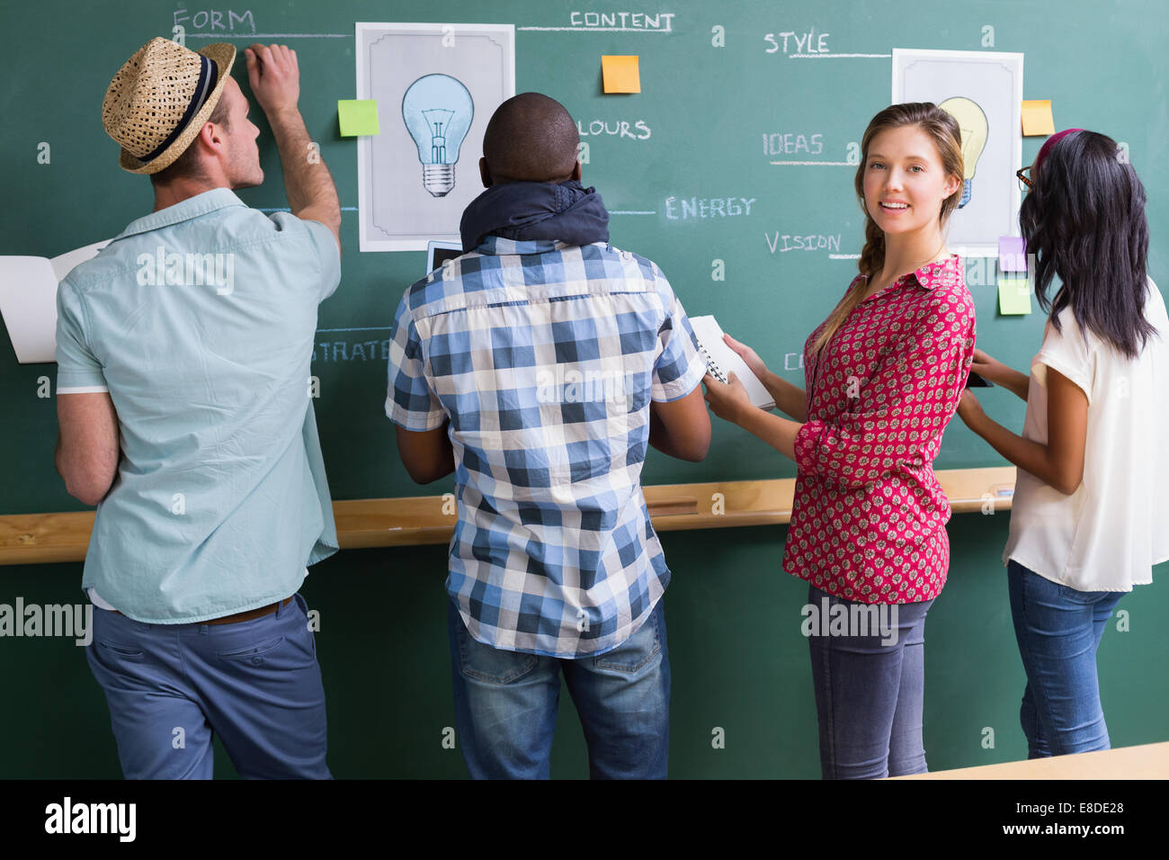 Creative business people at work by blackboard Stock Photo - Alamy