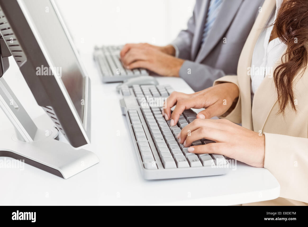 Hands using computers in office Stock Photo - Alamy