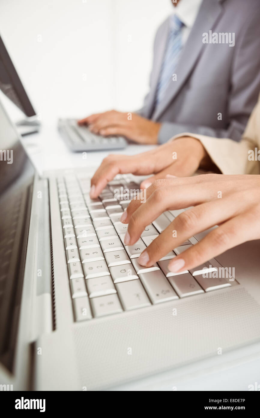 Hands using computers in office Stock Photo - Alamy