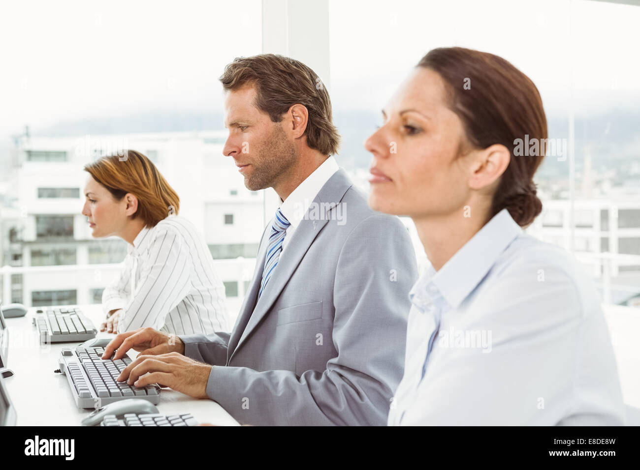 Business people using computers in office Stock Photo - Alamy