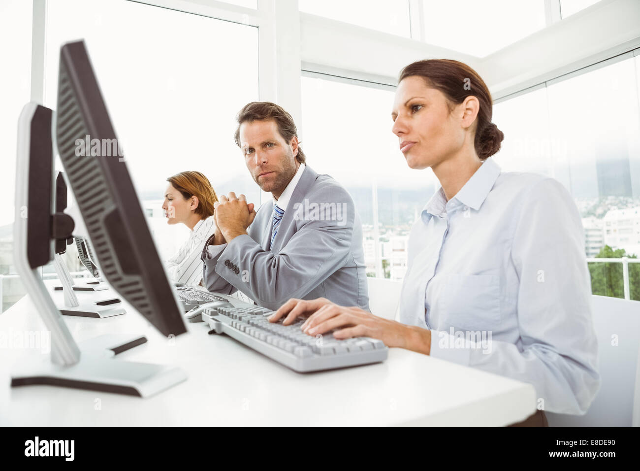 Business people using computers in office Stock Photo - Alamy
