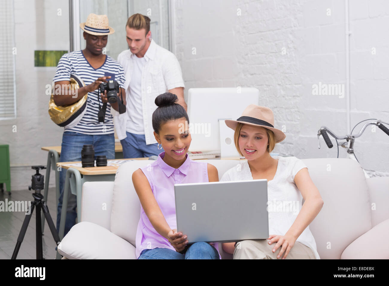 Casual business people using laptop Stock Photo - Alamy