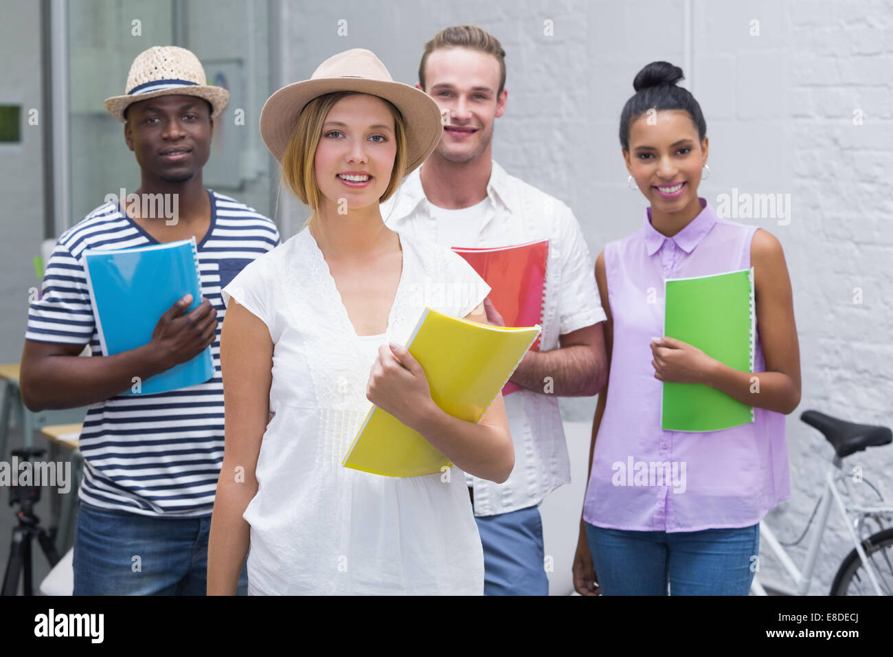 Portrait of creative business people holding files Stock Photo - Alamy