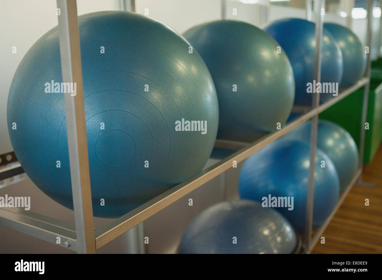 Exercise balls on rack in studio Stock Photo - Alamy