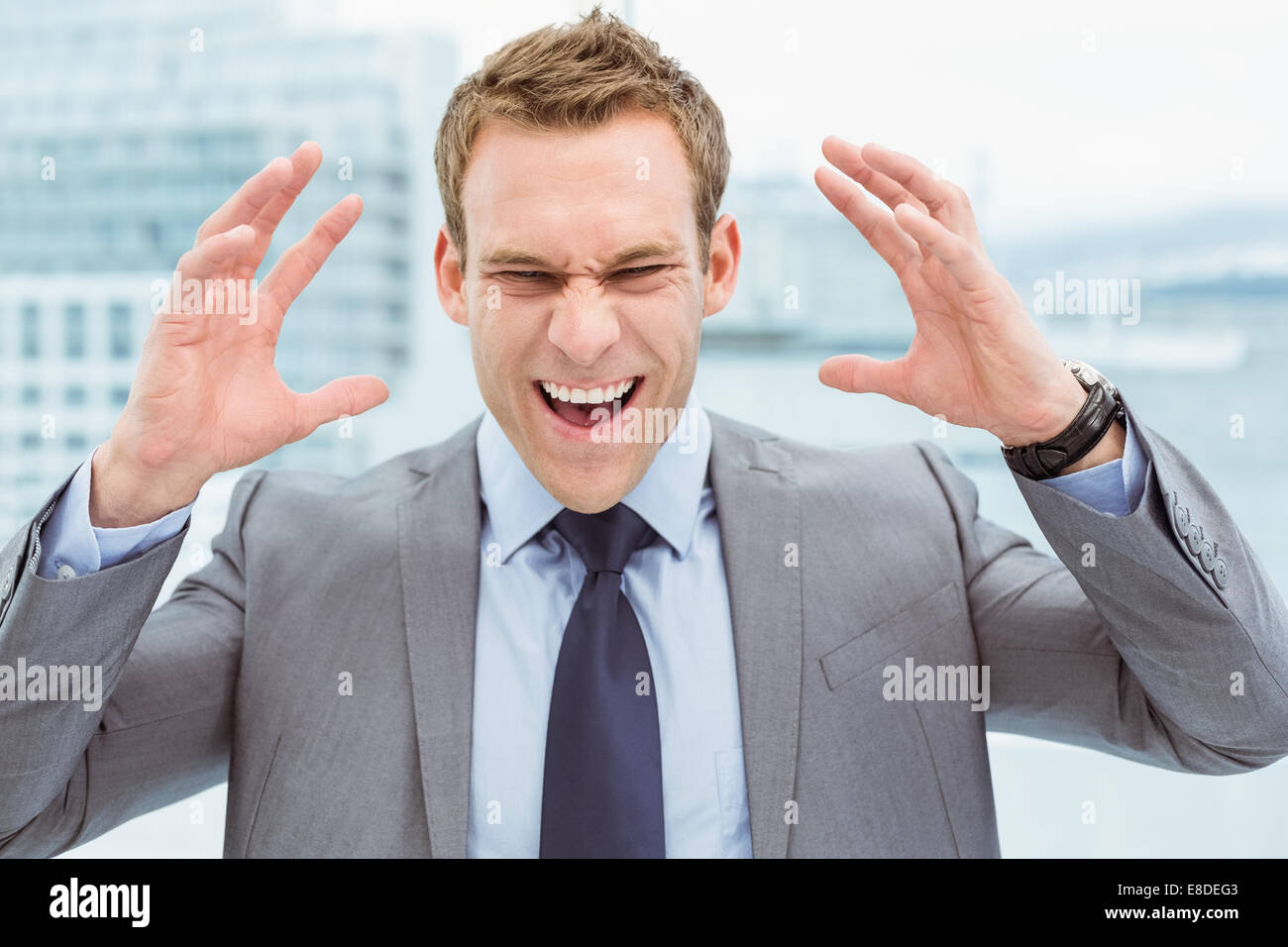 Angry young businessman at office Stock Photo - Alamy
