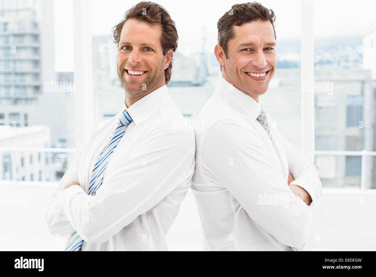 Confident happy businessmen in office Stock Photo - Alamy