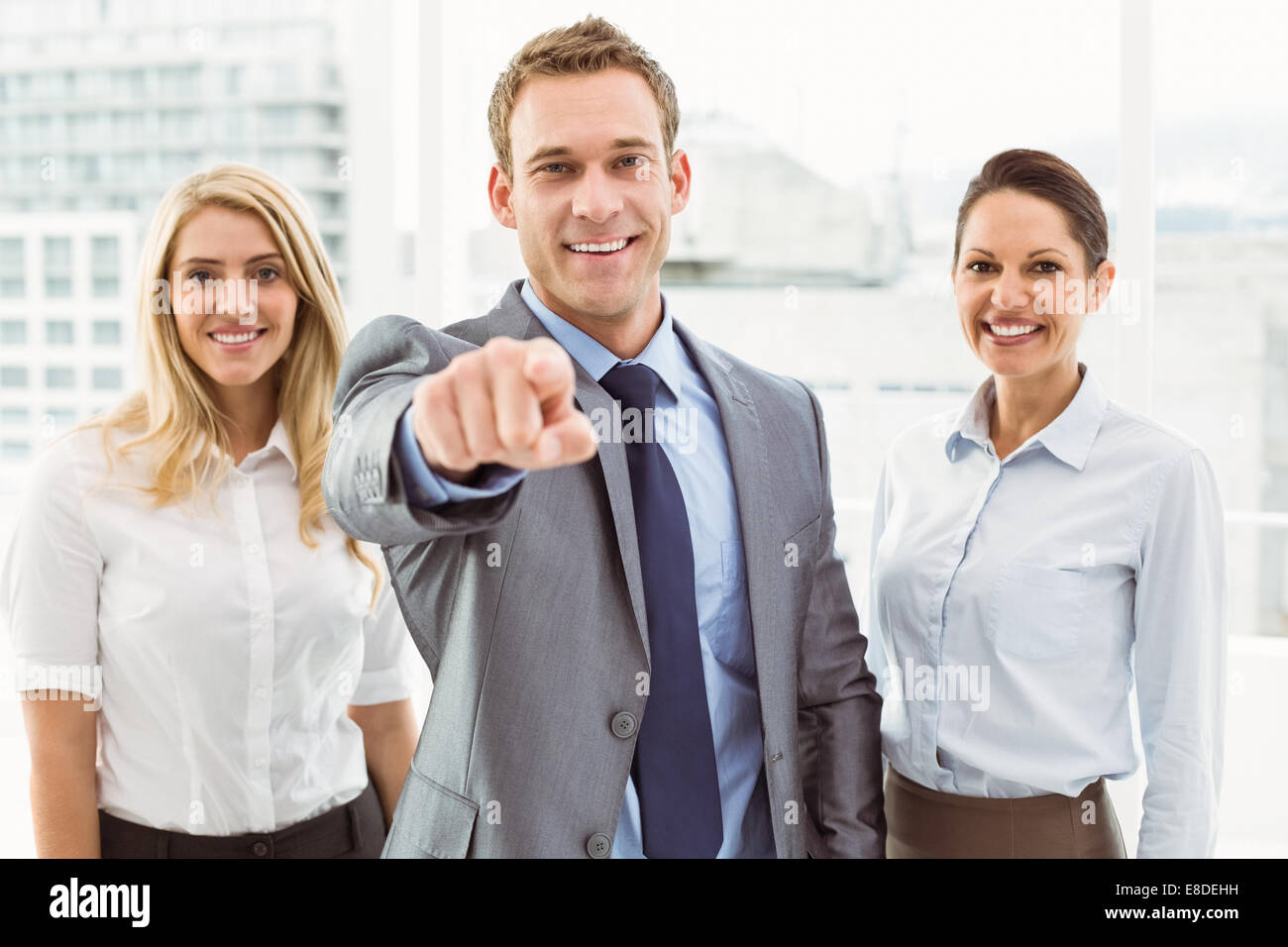 Businessman pointing at you with colleagues in office Stock Photo - Alamy