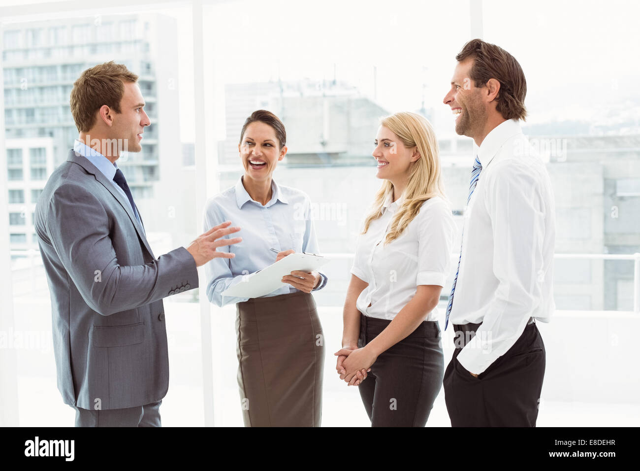 Cheerful colleagues in discussion at office Stock Photo - Alamy