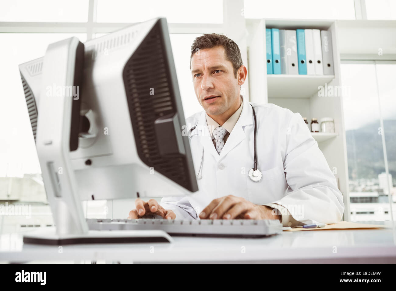 Doctor using computer at medical office Stock Photo - Alamy