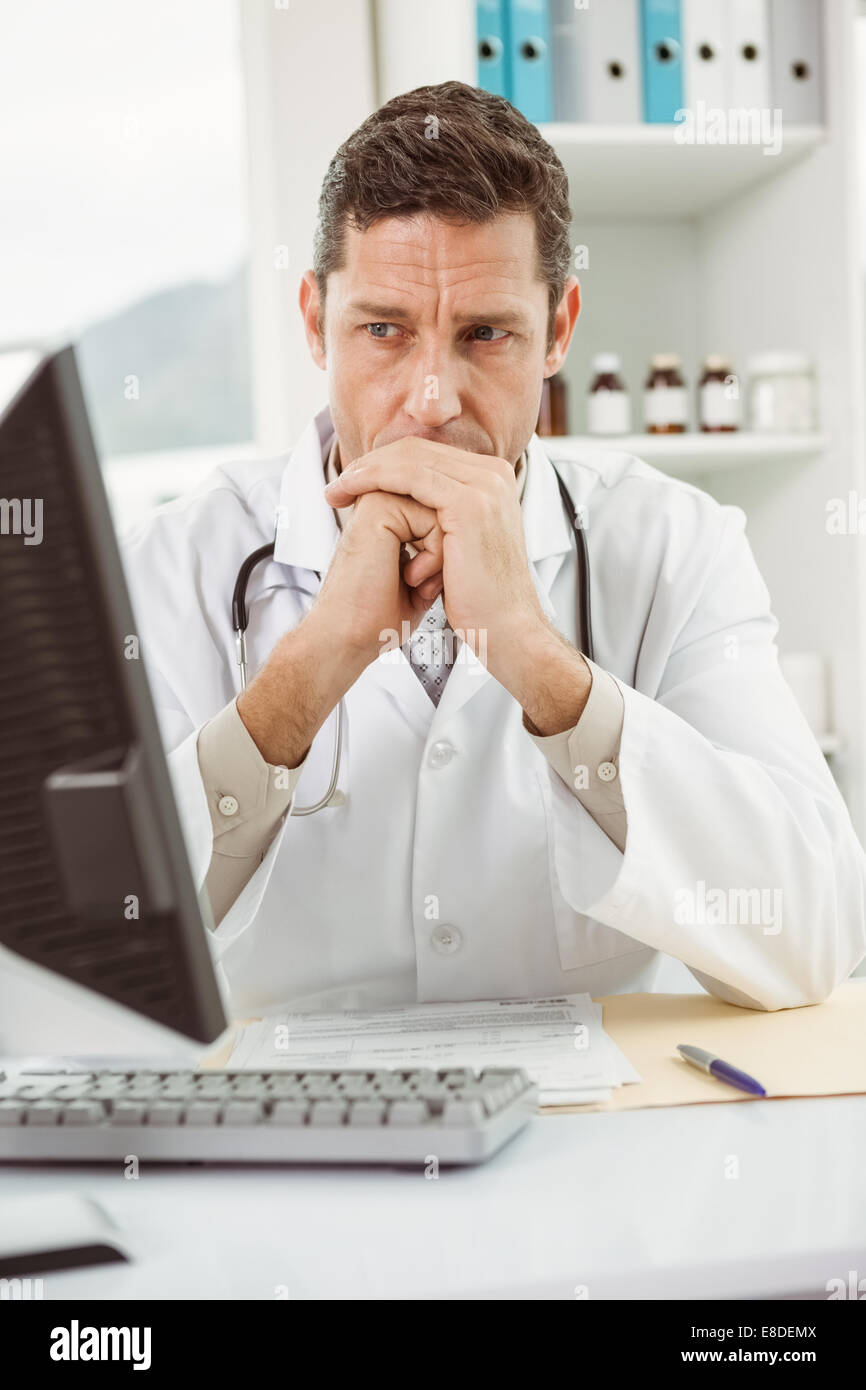 Doctor looking medical monitor hi-res stock photography and images - Alamy