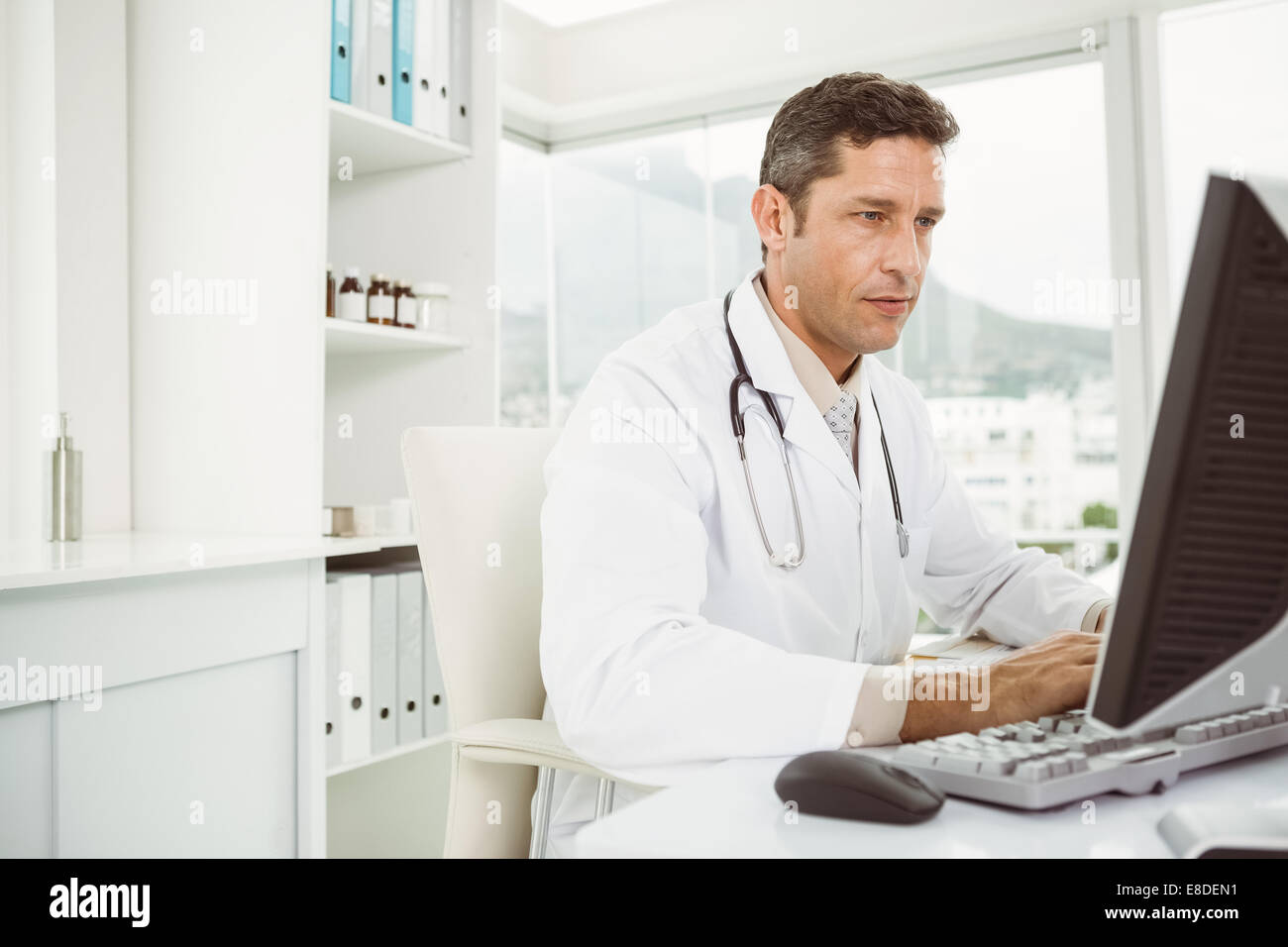Doctor using computer at medical office Stock Photo - Alamy