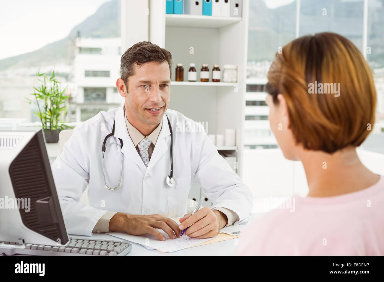 Doctor and patient in discussion at medical office Stock Photo - Alamy