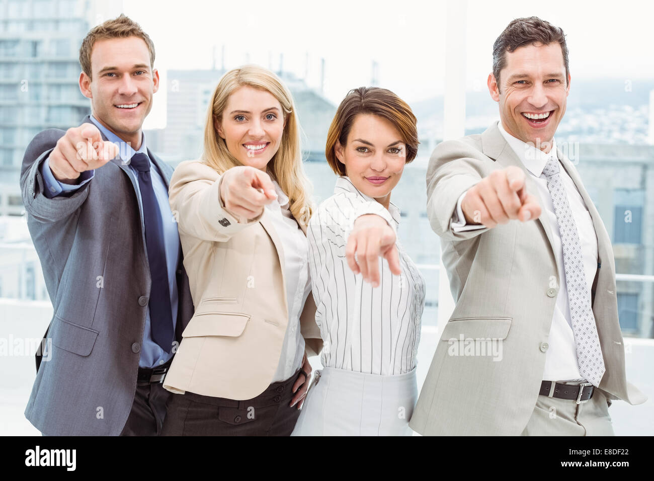 Happy business people pointing at you in office Stock Photo - Alamy