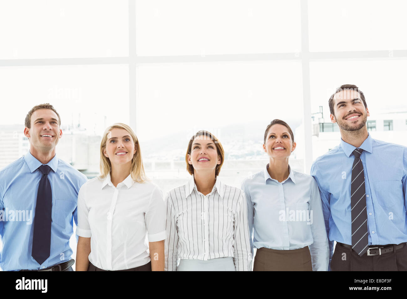 Business people looking up in office Stock Photo - Alamy