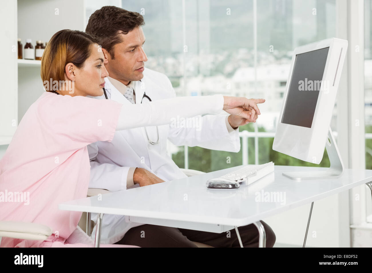 Doctors using computer at medical office Stock Photo - Alamy