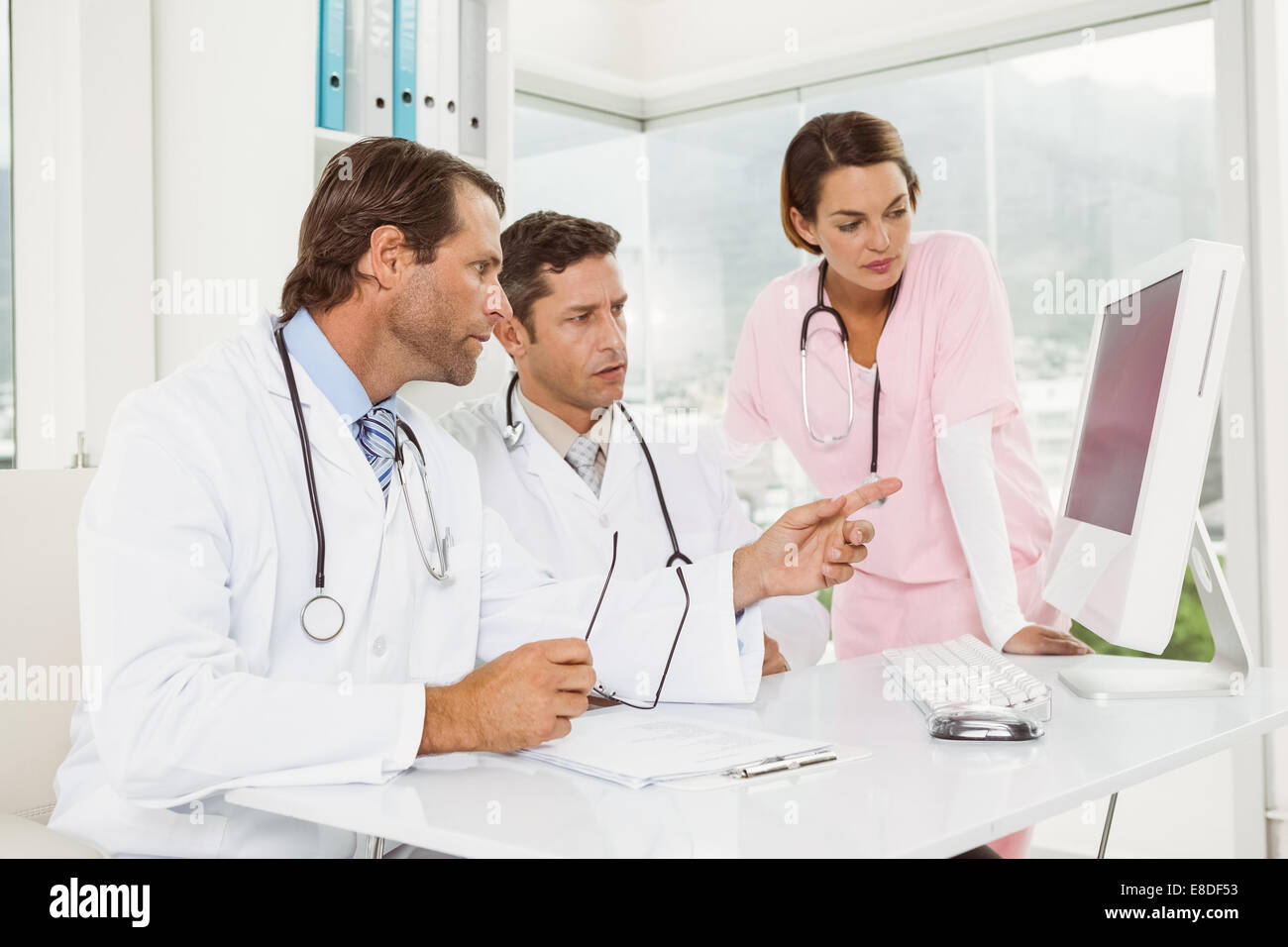 Doctors using computer at medical office Stock Photo - Alamy