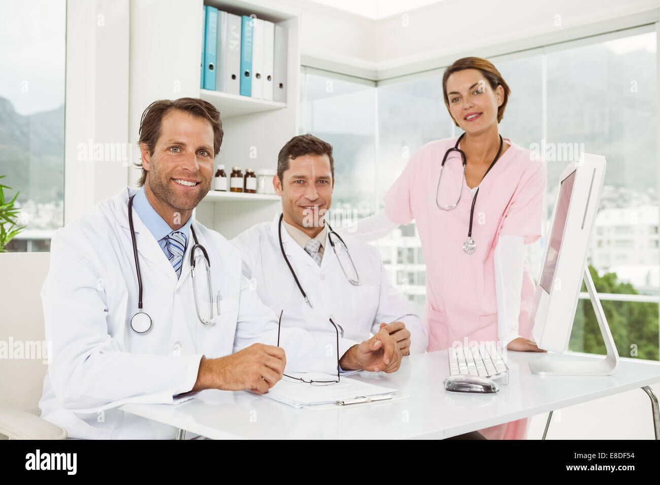 Confident doctors smiling at medical office Stock Photo - Alamy