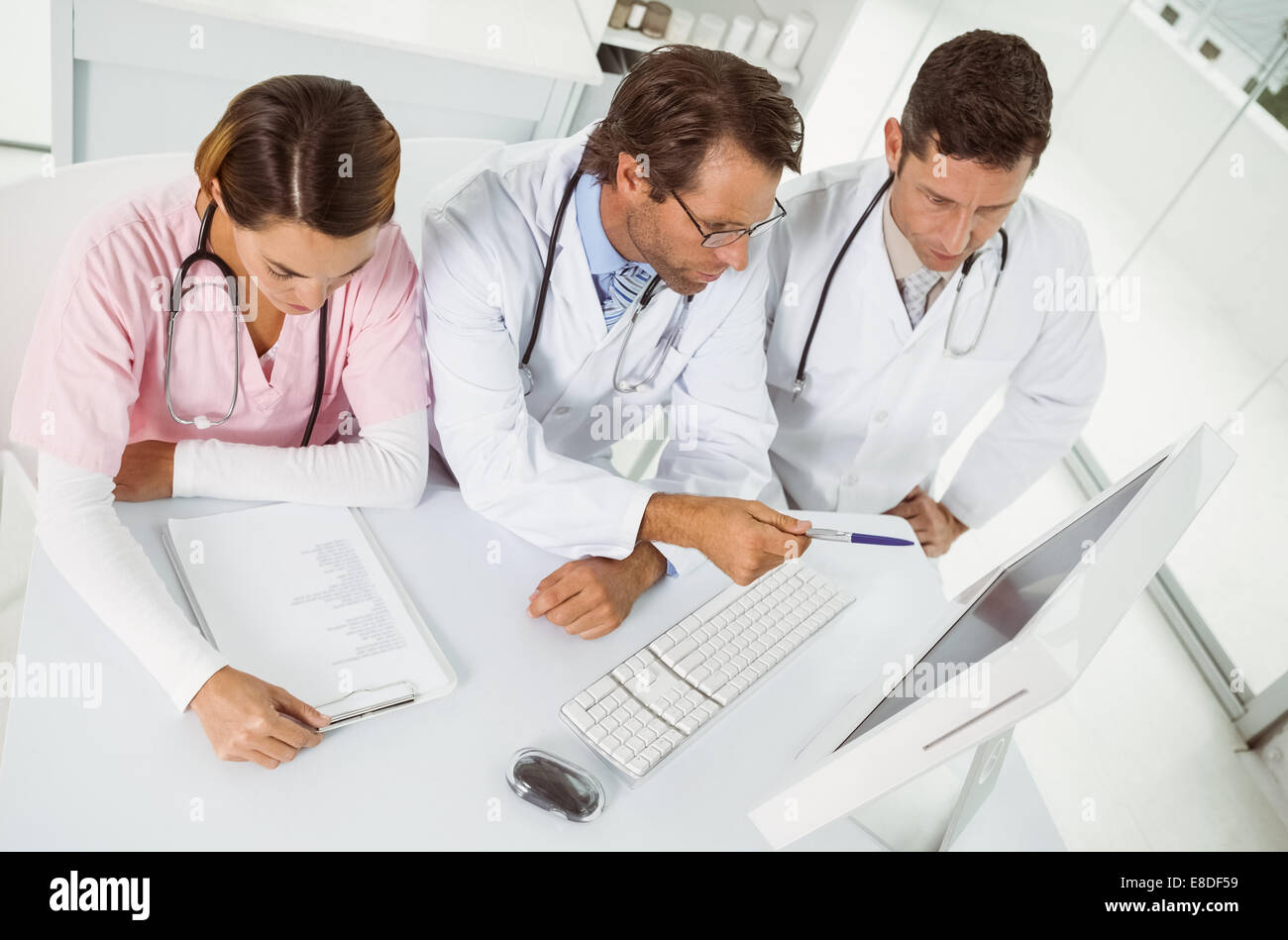 Doctors using computer at medical office Stock Photo - Alamy