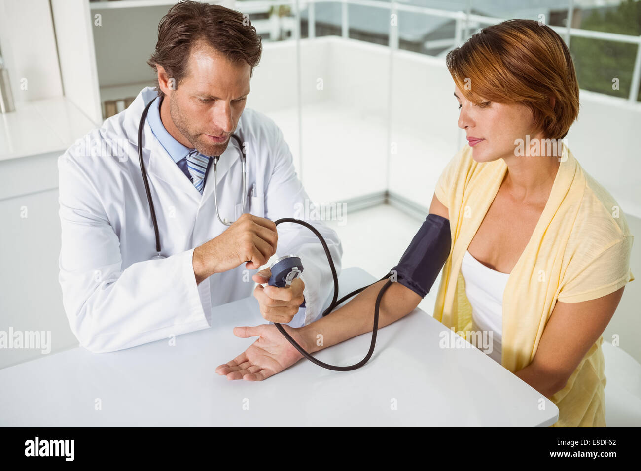 Checking blood pressure hi-res stock photography and images - Alamy